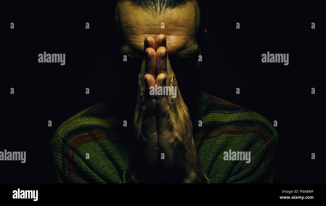 Single man praying hi-res stock photography and images - Alamy