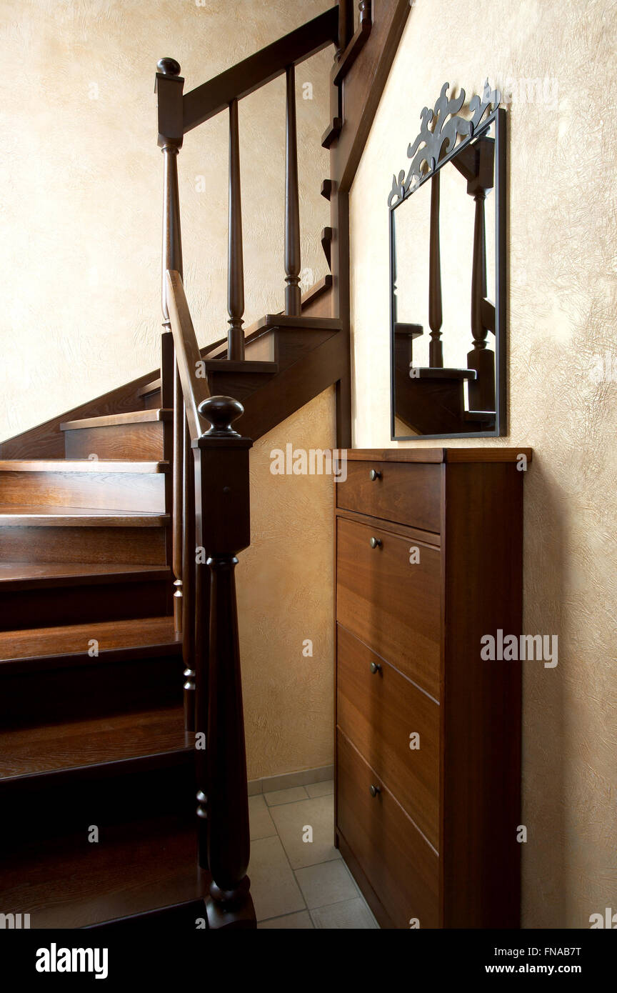 Wooden staircase and beautiful mirror in the modern house Stock Photo ...