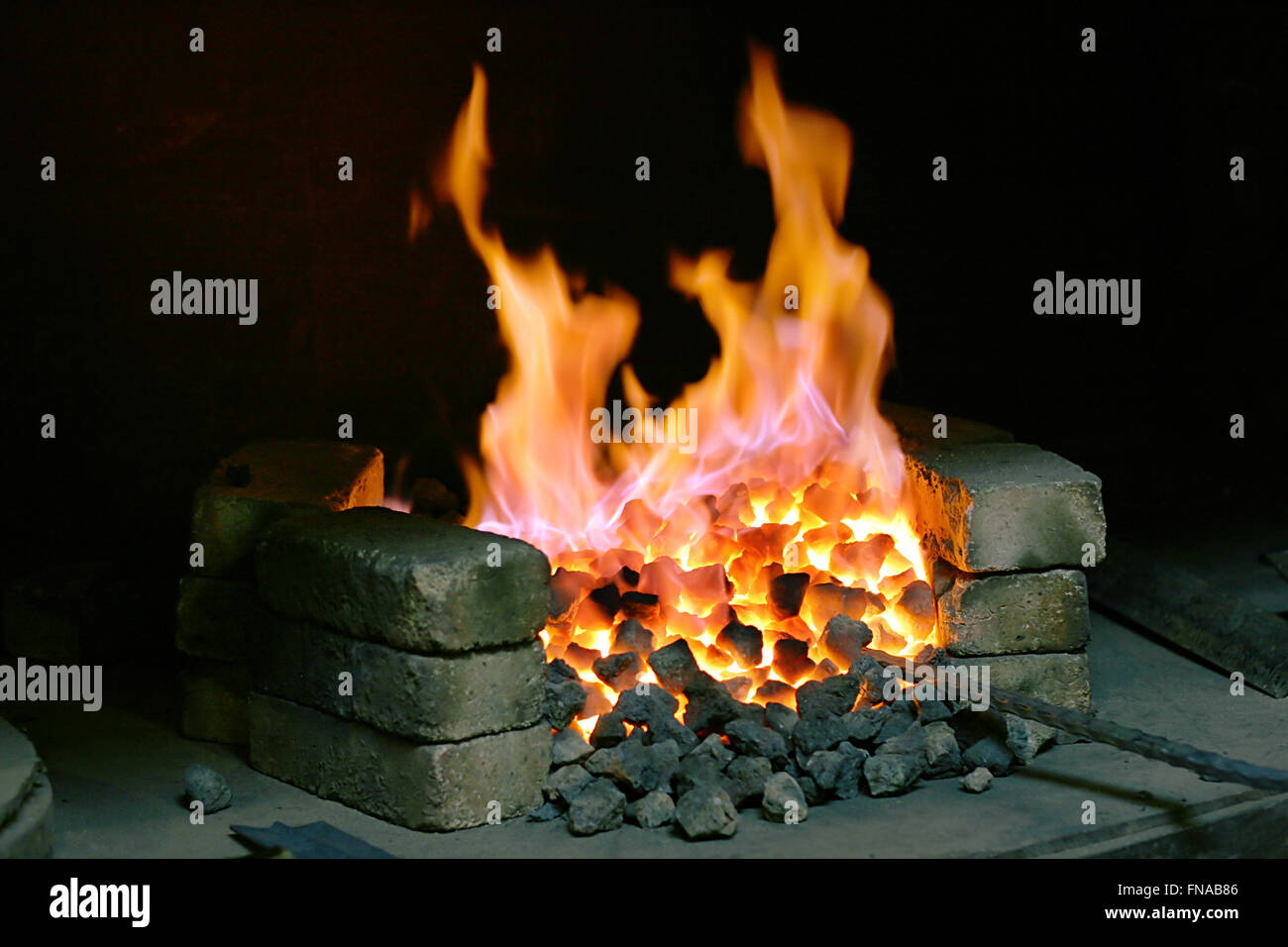 Metal detail on fire to an old smithy Stock Photo - Alamy