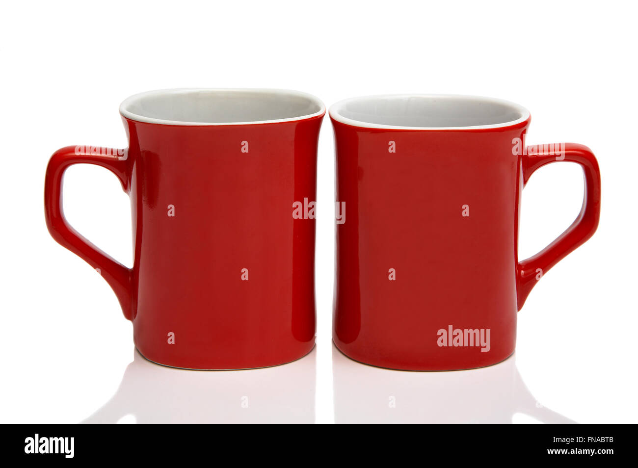 Two red cups on a white background Stock Photo - Alamy