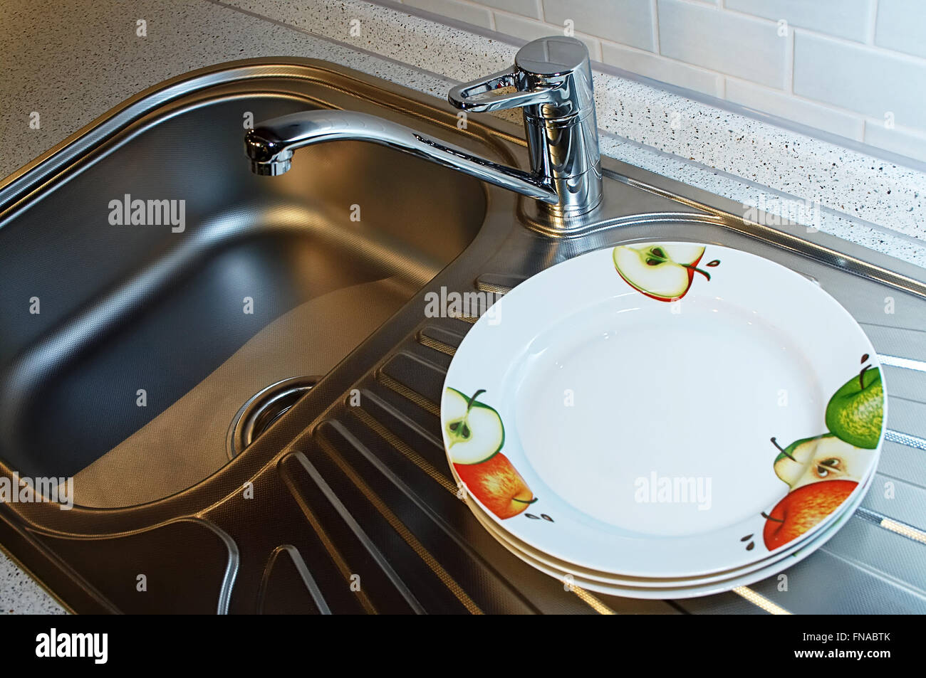 Pure plates on a new kitchen sink Stock Photo - Alamy