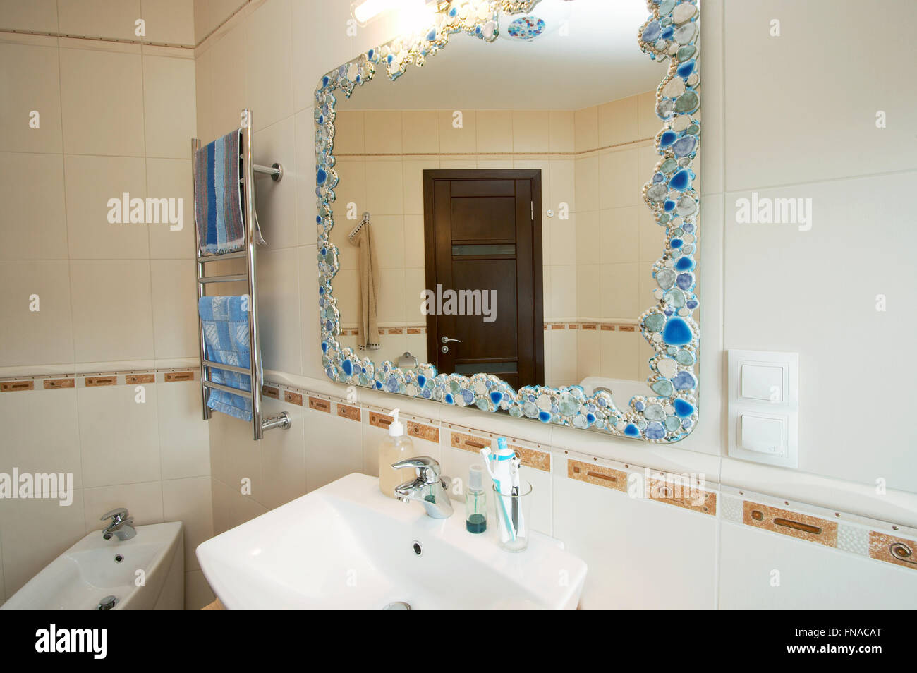 Reflection of a door in a mirror to a modern bathroom Stock Photo - Alamy