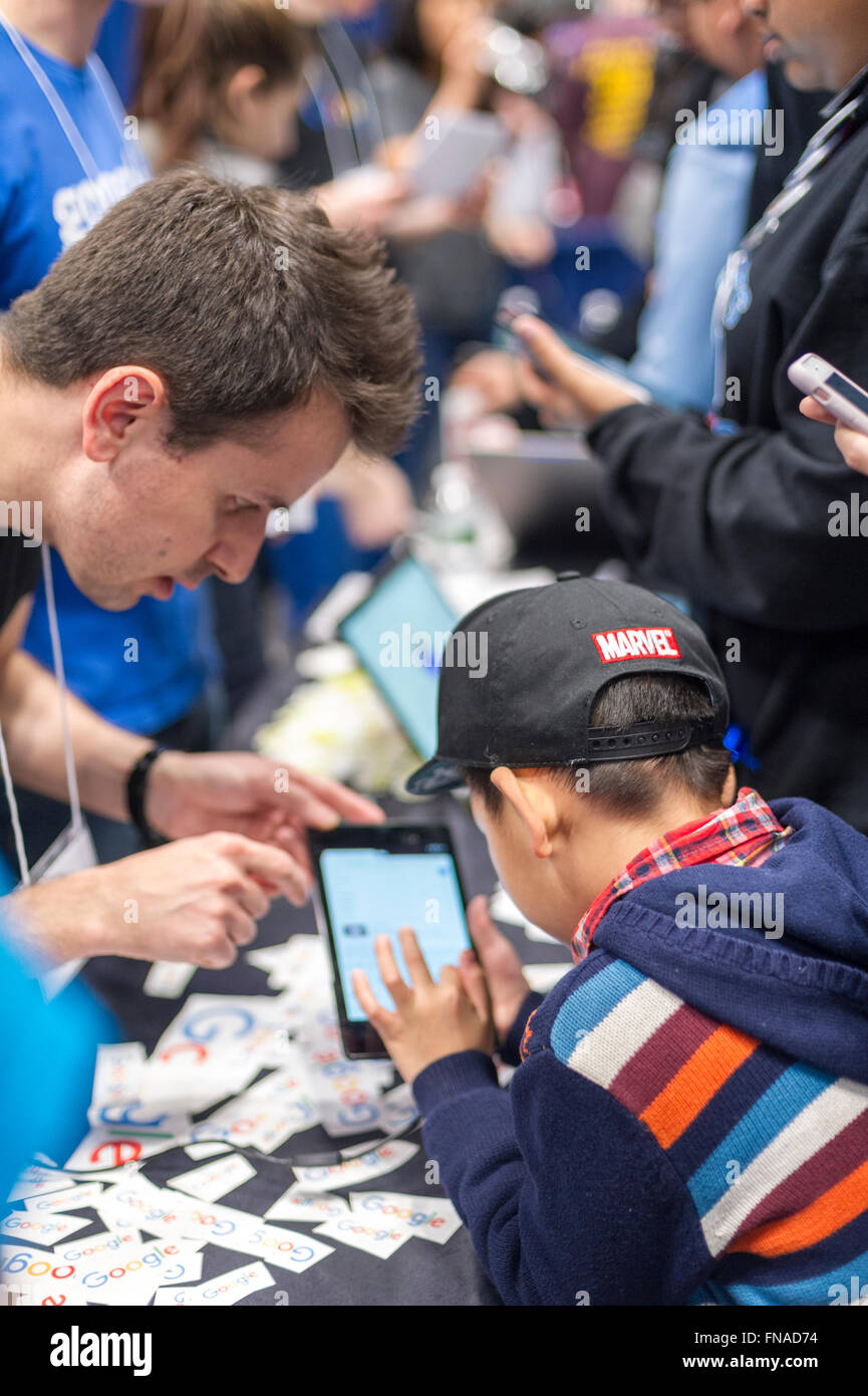 Workers from Google interact with visitors at a Career Expo held at the ...