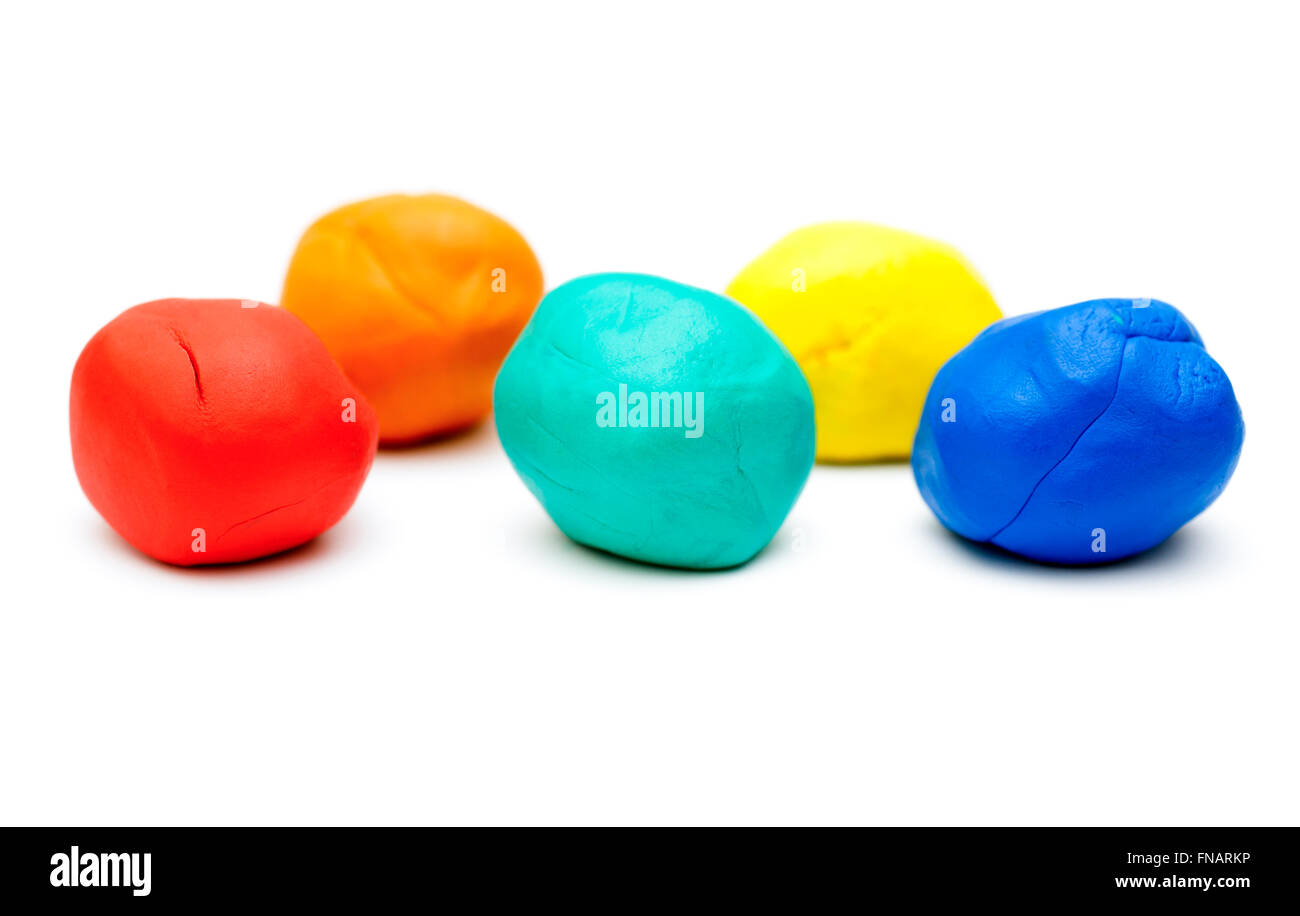 Five pieces of colored plasticine on white background Stock Photo - Alamy
