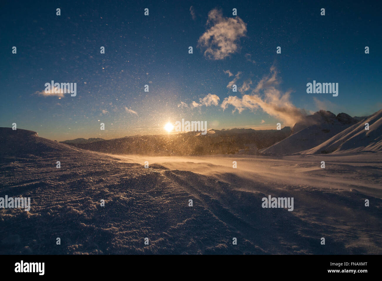 Sunset in the snowy alps Stock Photo - Alamy