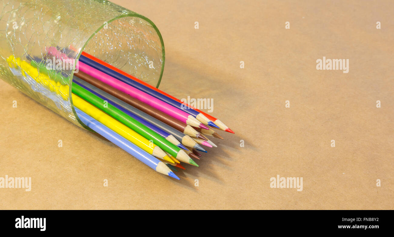 Color pencil set in a glass container on craft paper Stock Photo - Alamy
