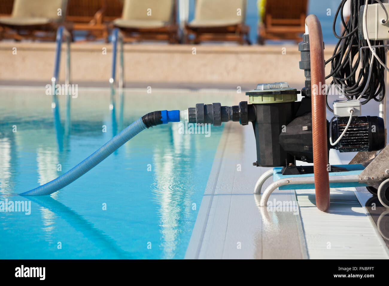 Cleaning pump working with a swimming pool. Horizontal shot Stock Photo ...