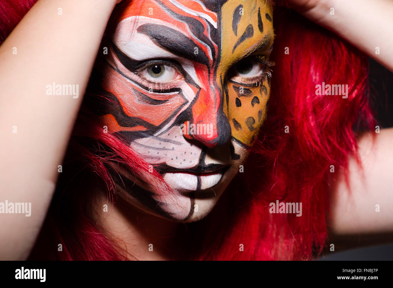 Woman with tiger face in halloween concept Stock Photo - Alamy