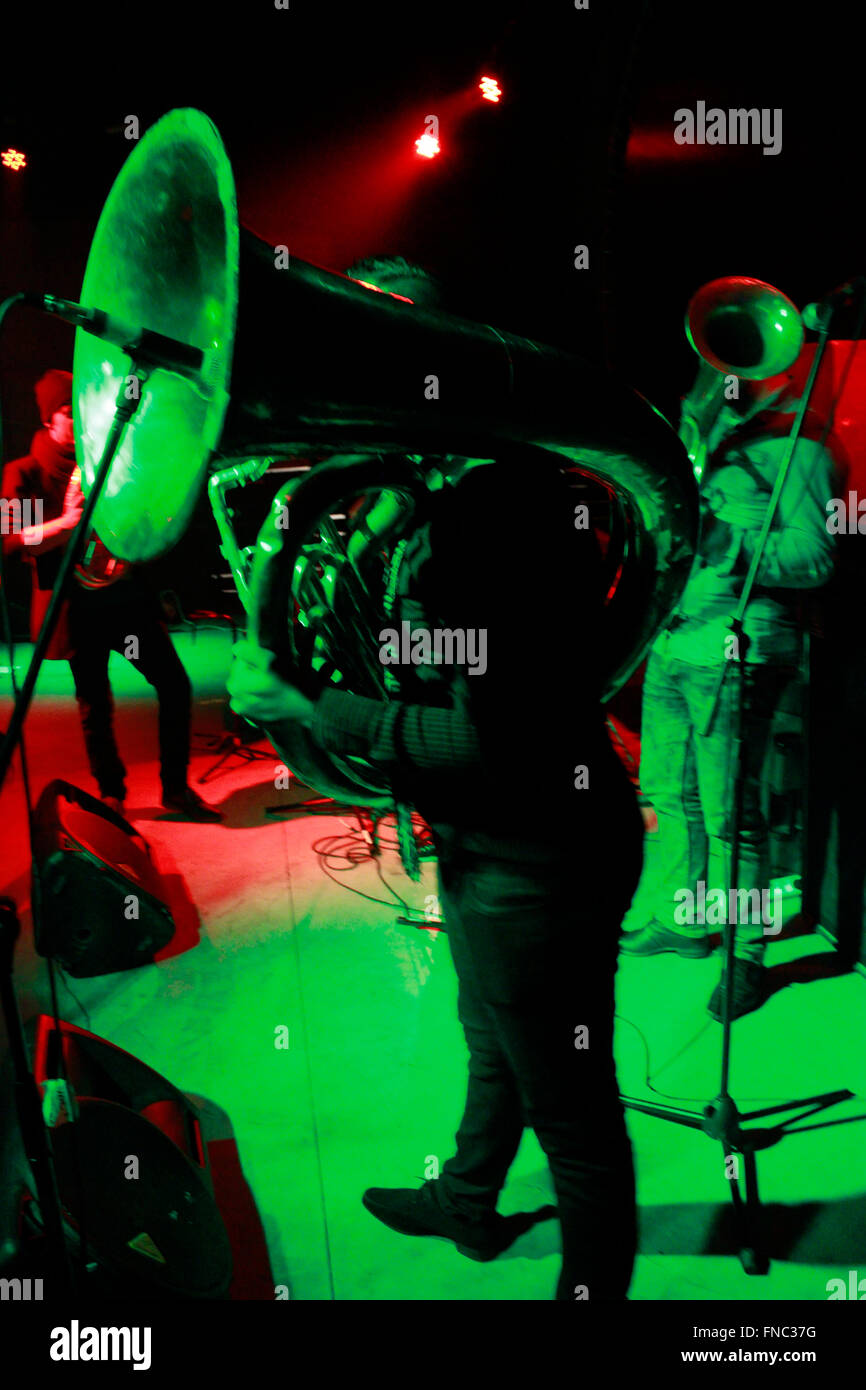 Sousaphone player (Luboyna band) lit by stage lighting during ...