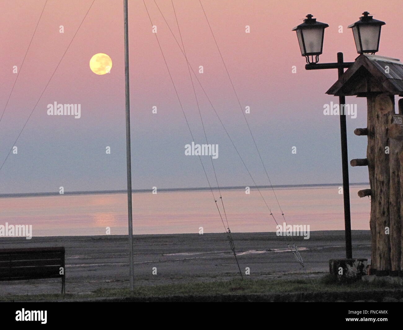calm sea in the evening, full moon Stock Photo - Alamy