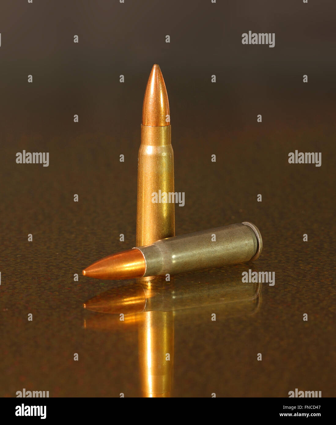 Two bullets against a dark background Stock Photo - Alamy