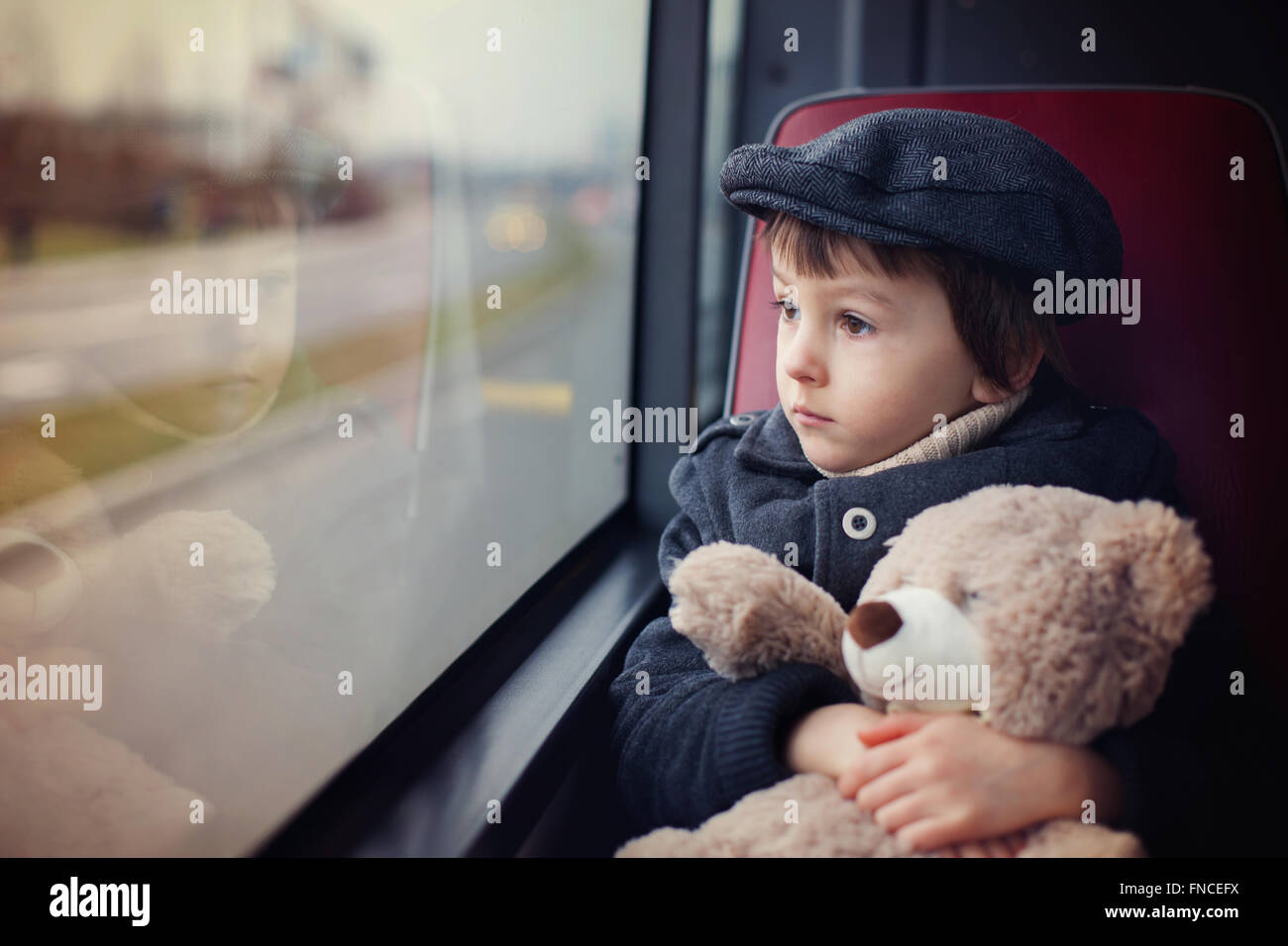 Sweet little child, preschool boy, riding in a bus, daytime, holding ...