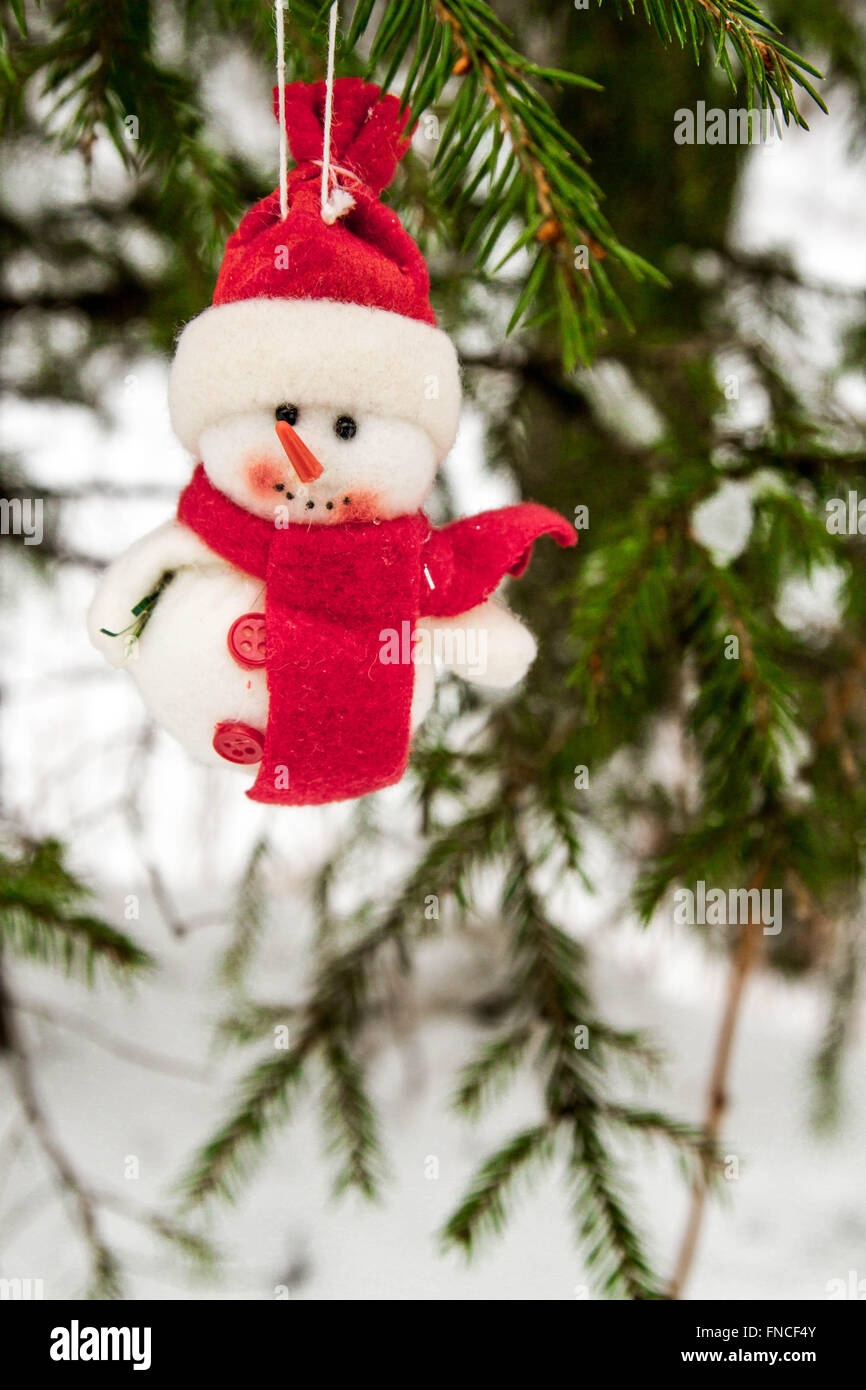 Toy snowman hanging on a snow-covered tree Stock Photo - Alamy