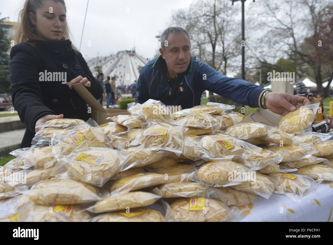 Tirana. 14th Mar, 2016. People buy tradational food "Ballakume" to ...