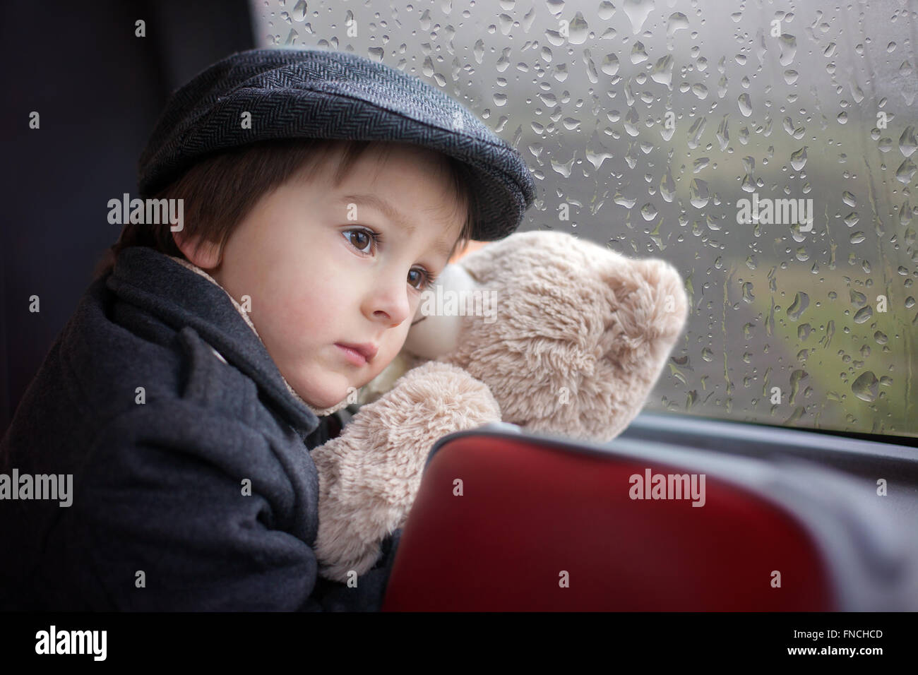 Sweet little child, preschool boy, riding in a bus, daytime, holding ...