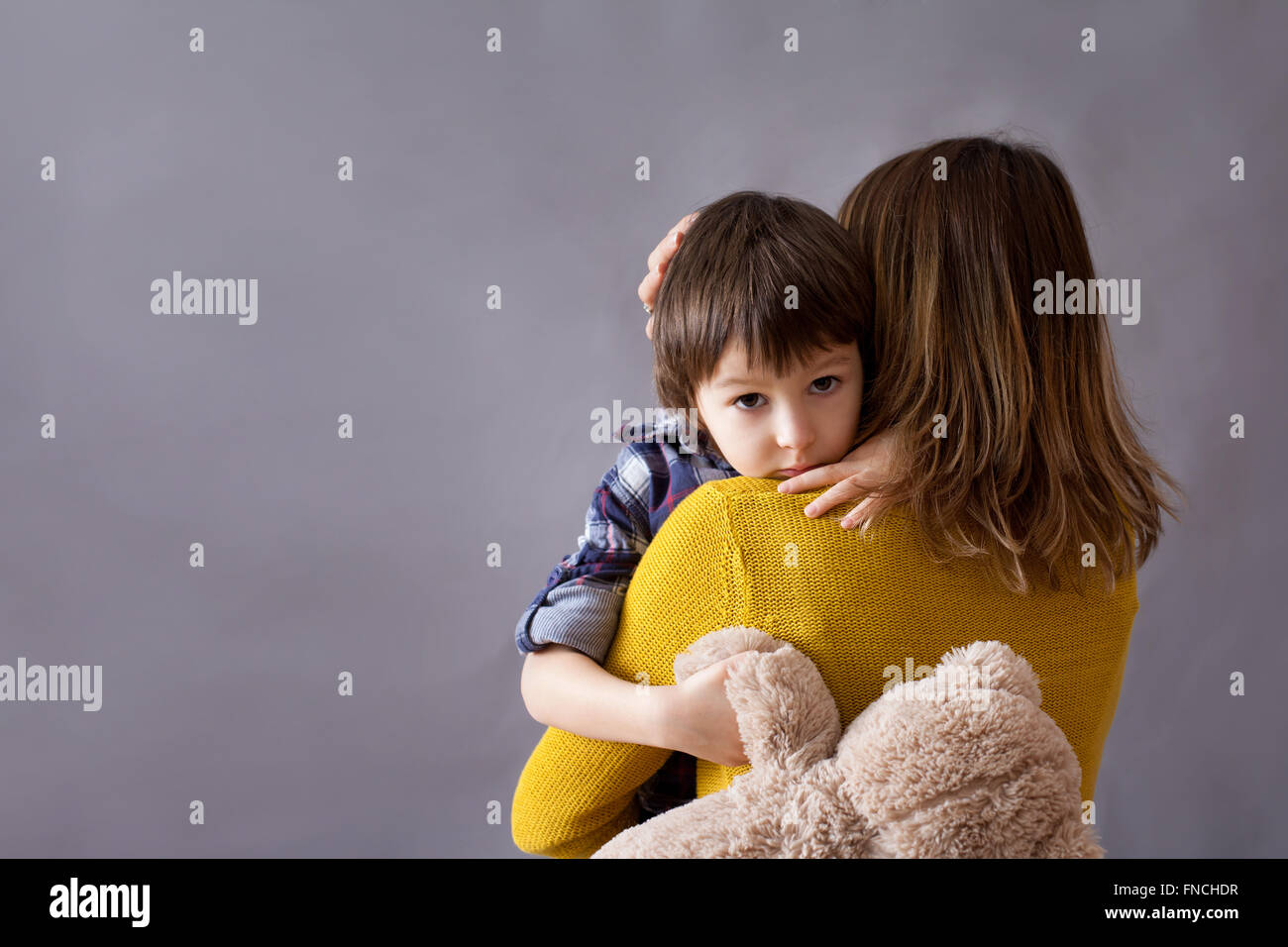 Mother hugging son sad hi-res stock photography and images - Alamy