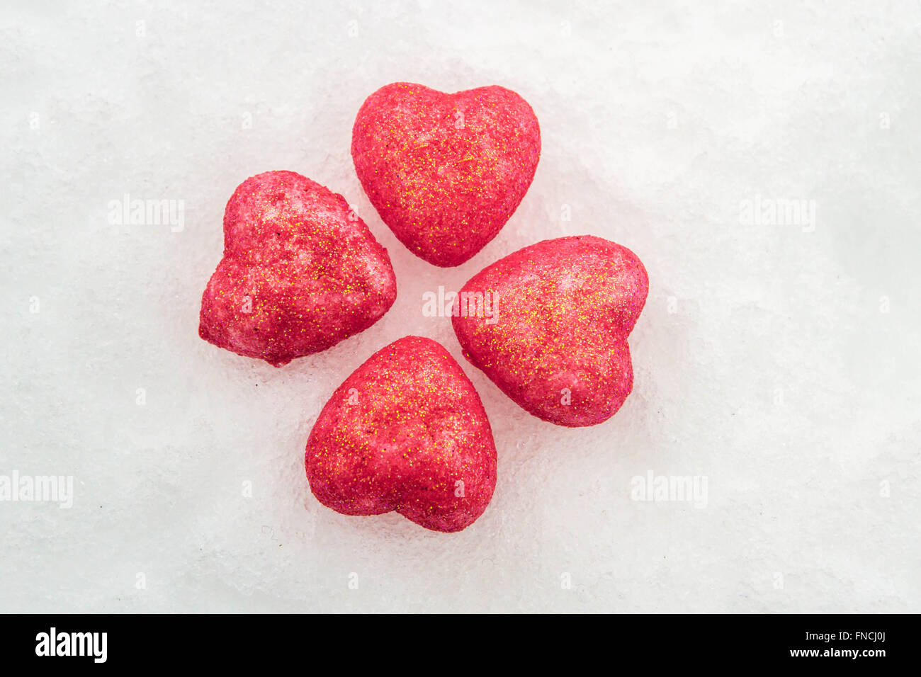 Pink hearts in the snow Stock Photo - Alamy