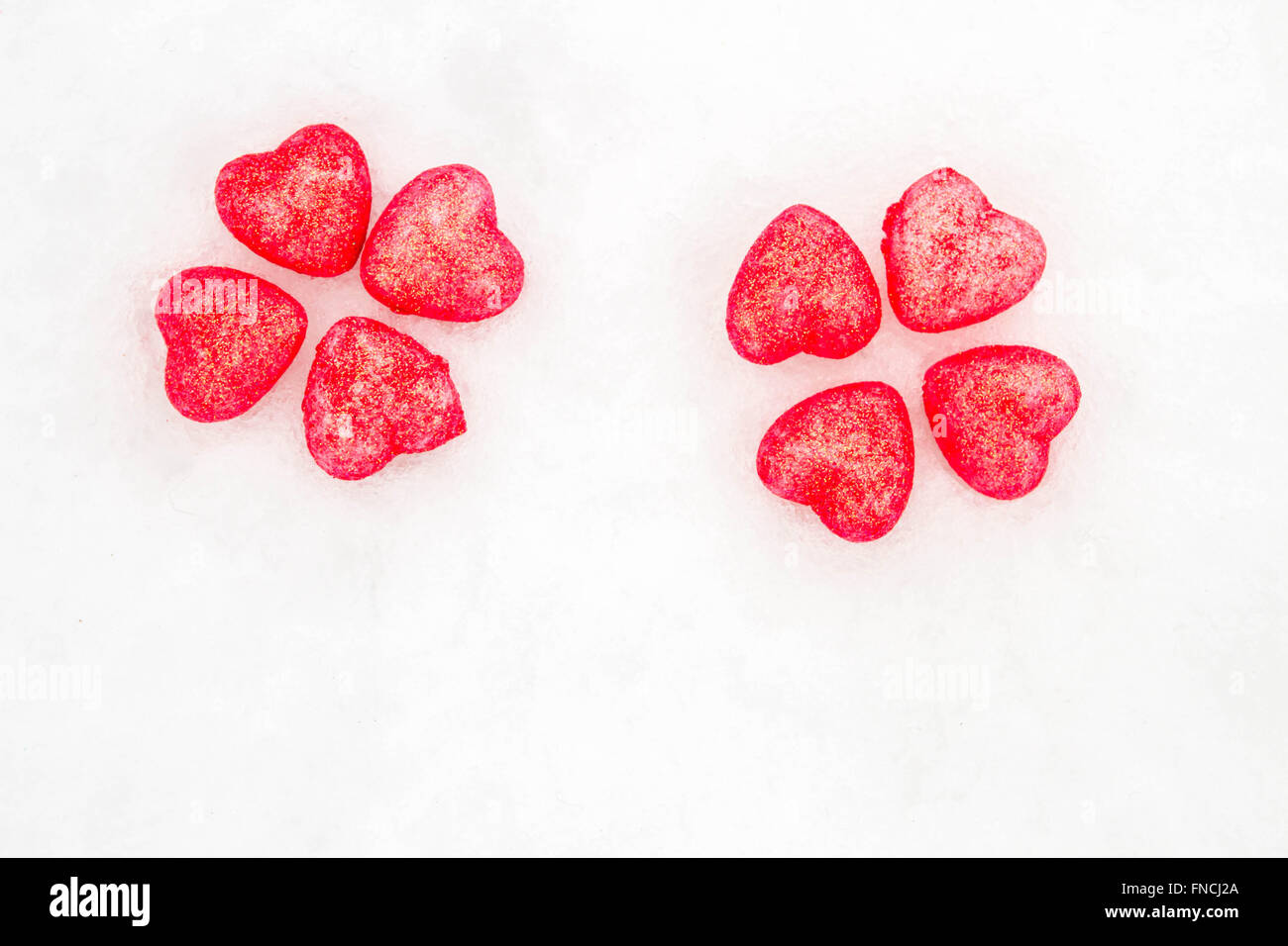 Pink hearts in the snow Stock Photo - Alamy