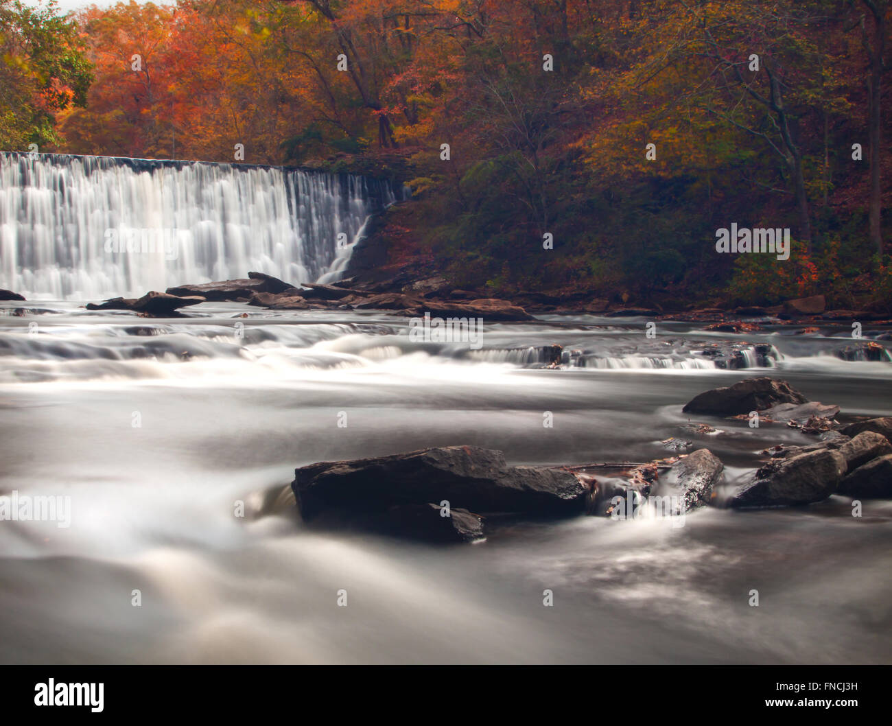 soft slow moving creek below a dam shot with long exposure Stock Photo ...