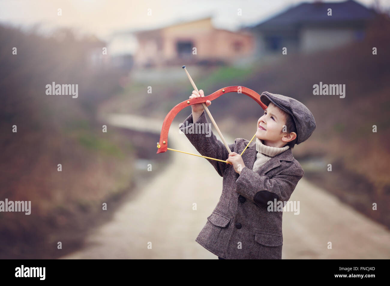 Adorable little preschool boy, shoot with bow and arrow at target in ...