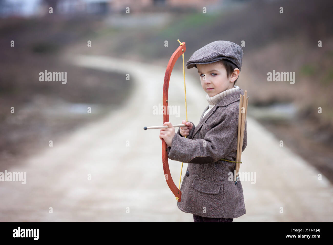 Adorable little preschool boy, shoot with bow and arrow at target in ...