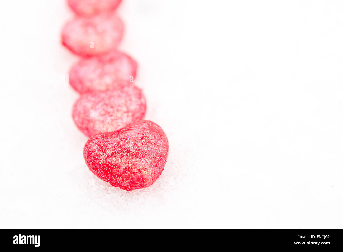 Pink hearts in the snow Stock Photo - Alamy