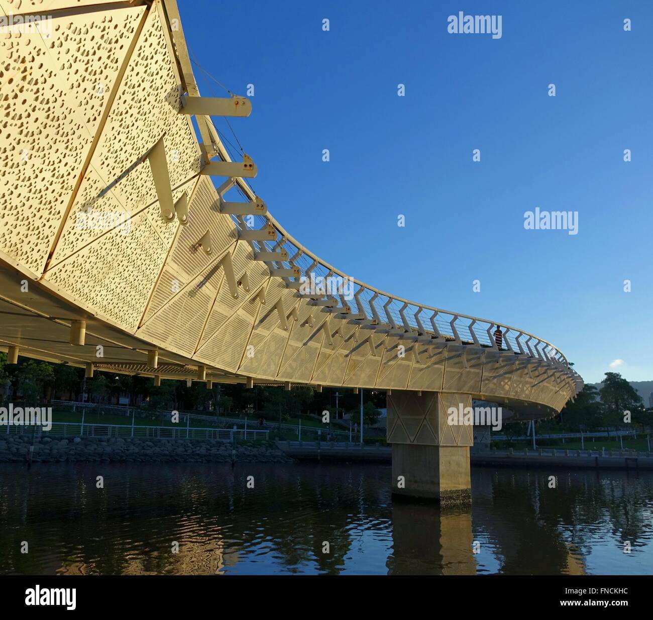 A curved pedestrian bridge located in a public park in Kaohsiung ...