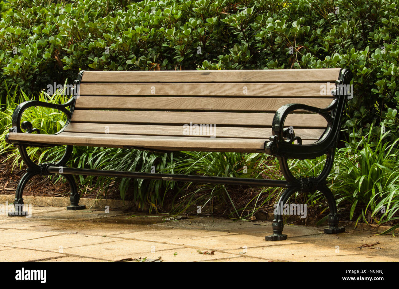 wooden park square bench with iron sides Stock Photo - Alamy