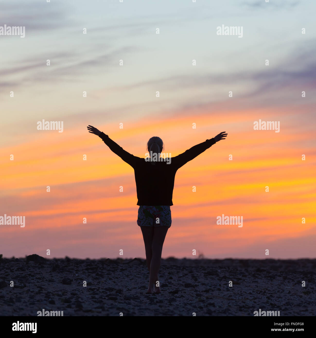 Woman enjoying freedom at sunset Stock Photo - Alamy