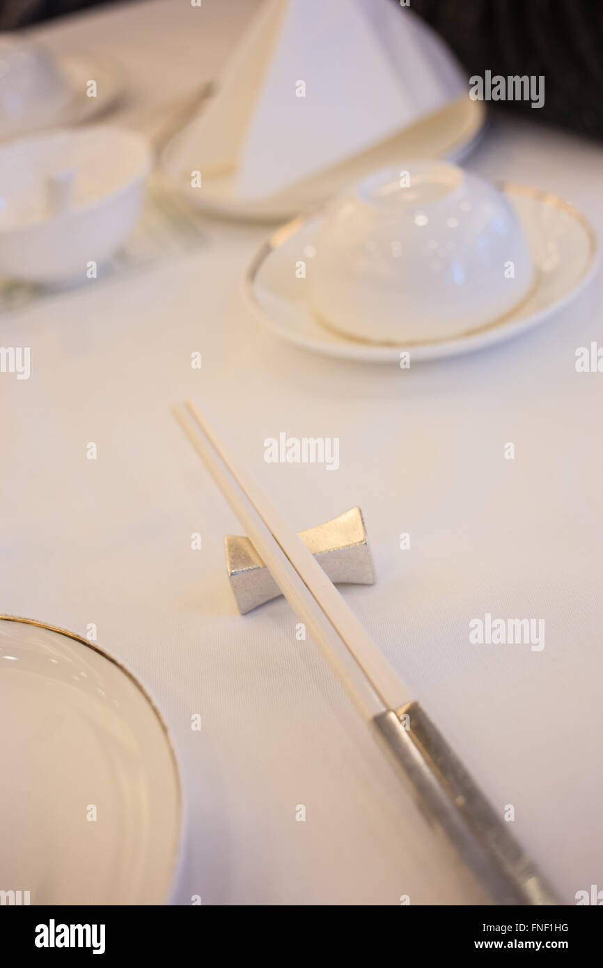 Chopsticks resting on stand at dim sum restaurant, Chinese restaurant ...