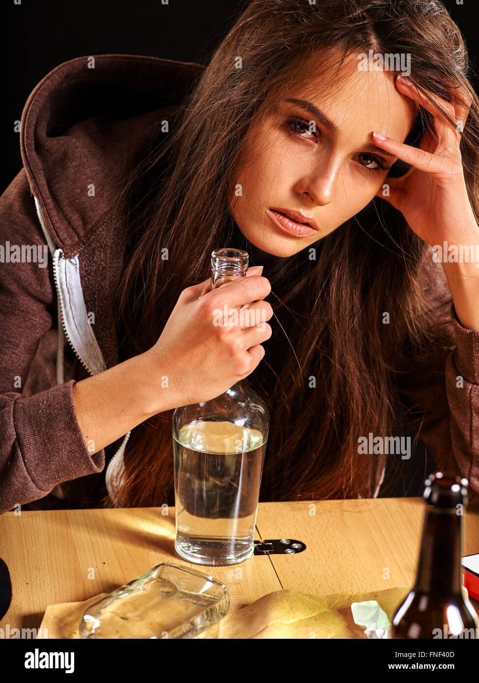 Drunk girl holding bottle of vodka Stock Photo - Alamy