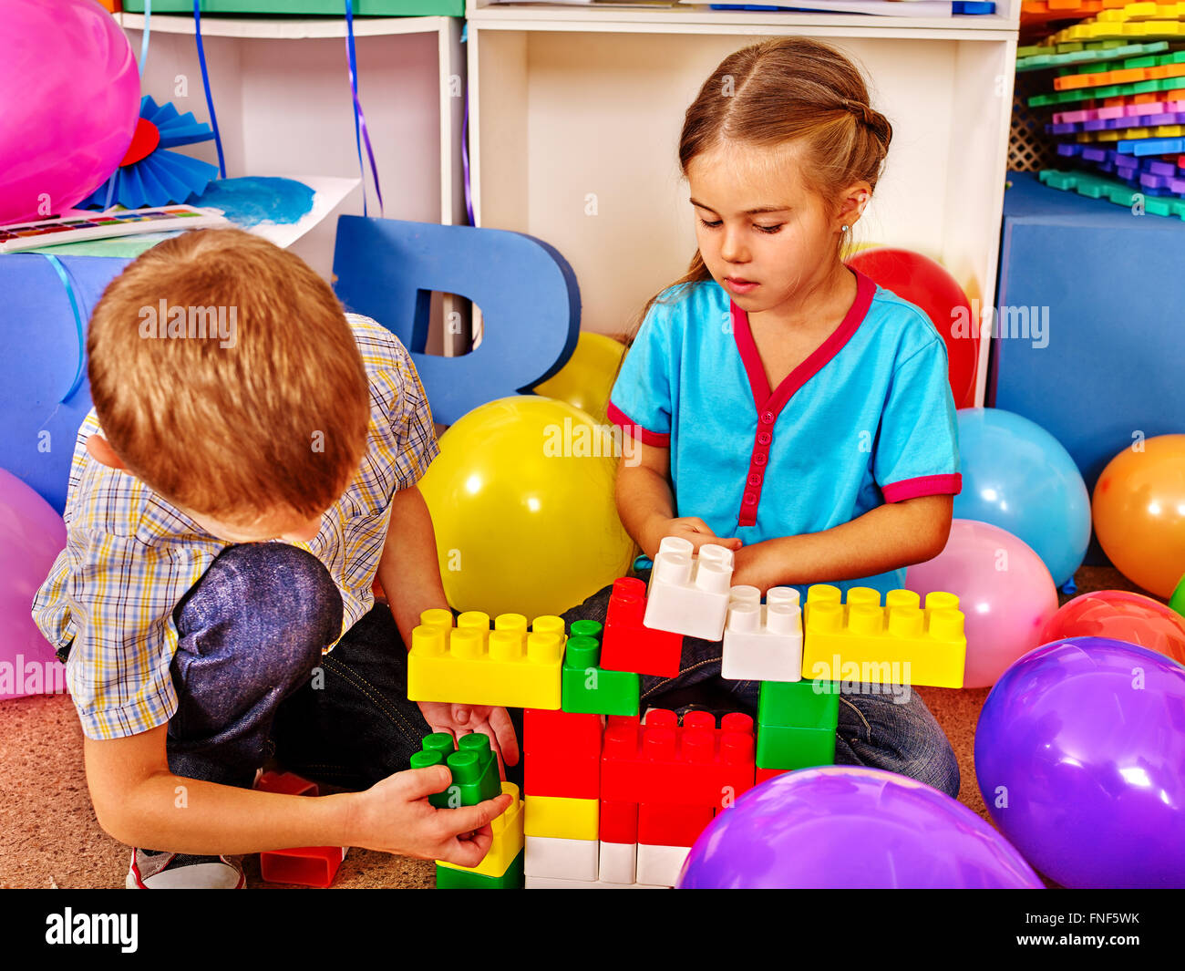 Group children game blocks on floor Stock Photo - Alamy