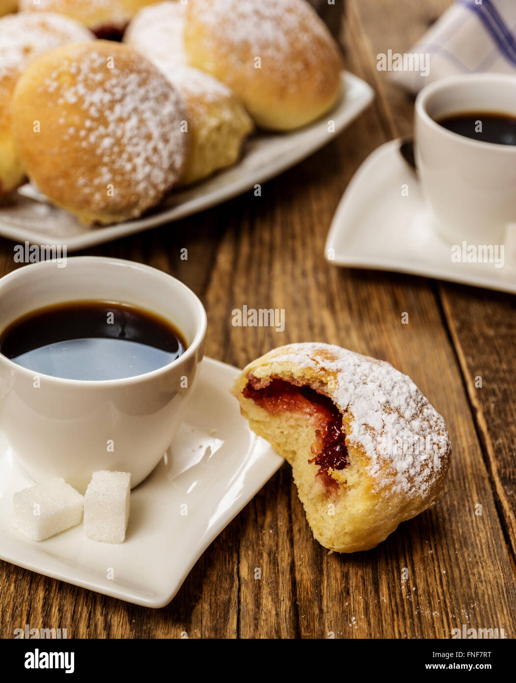 Traditional breaded cake with strawberry jam on wood table Stock Photo ...