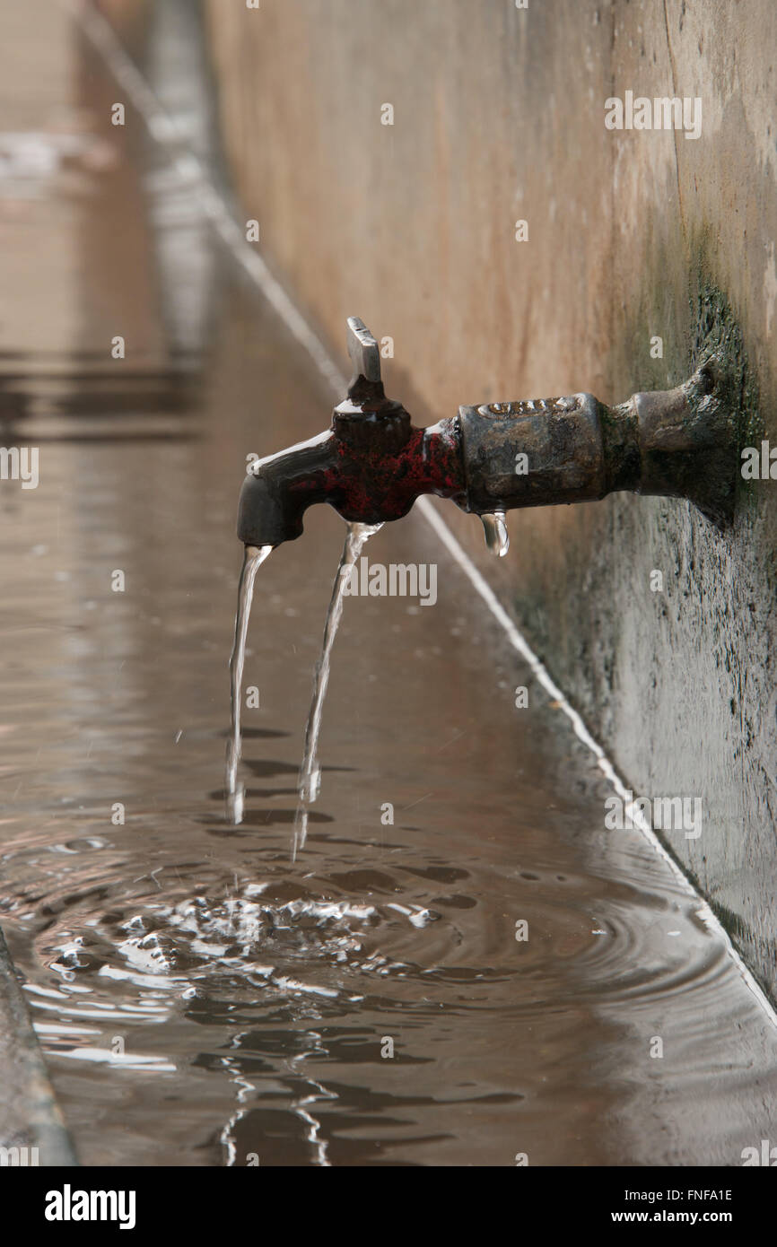 Dripping tap in street Stock Photo - Alamy