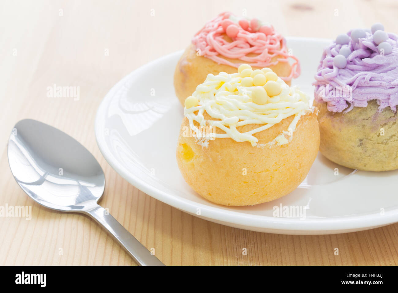 Highlight at yellow choux pastry or cream puff or profiterole that have ...