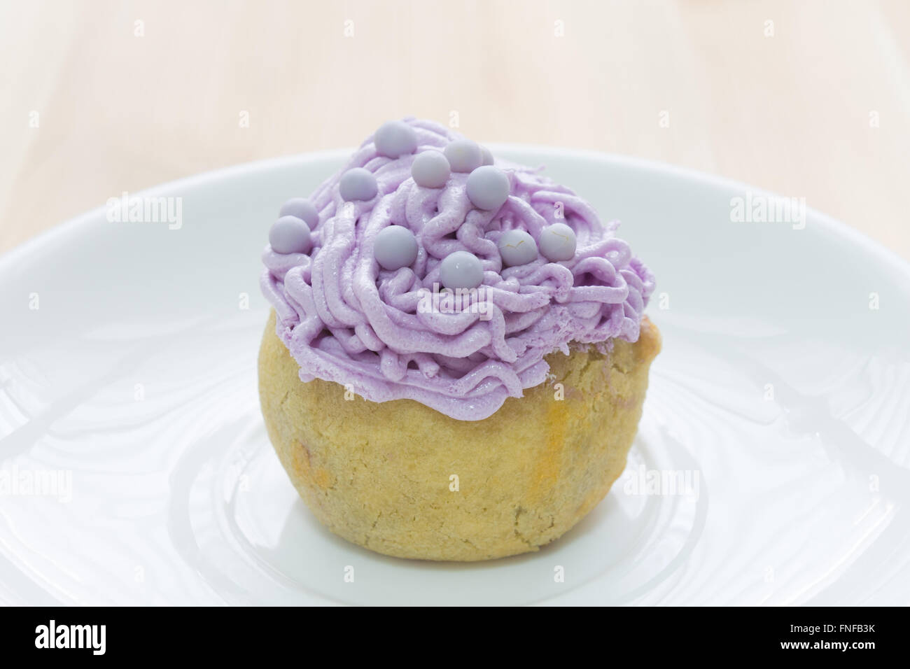 Purple choux pastry or cream puff or profiterole that have whipped ...