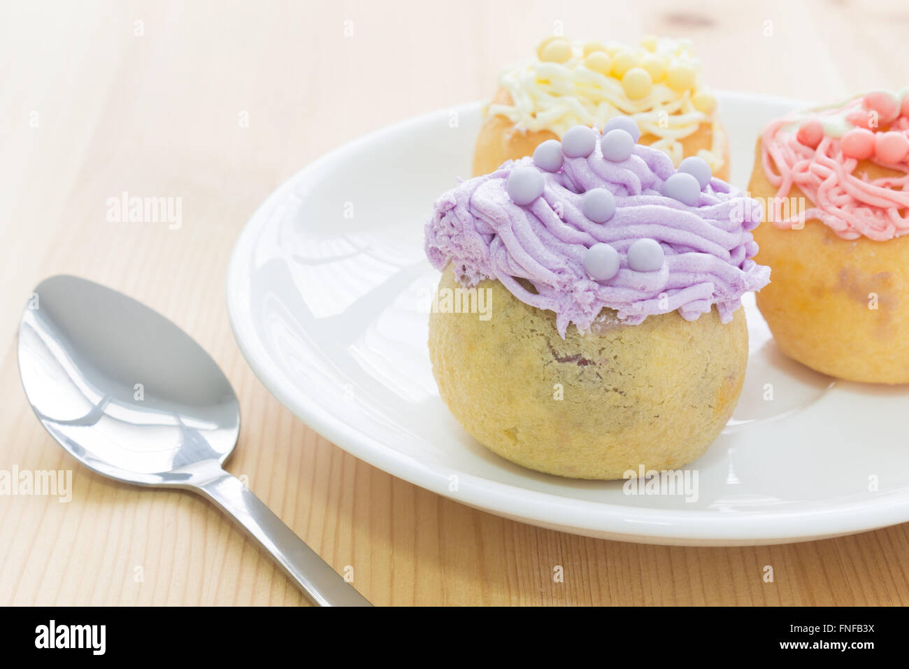 Highlight at purple choux pastry or cream puff or profiterole that have ...