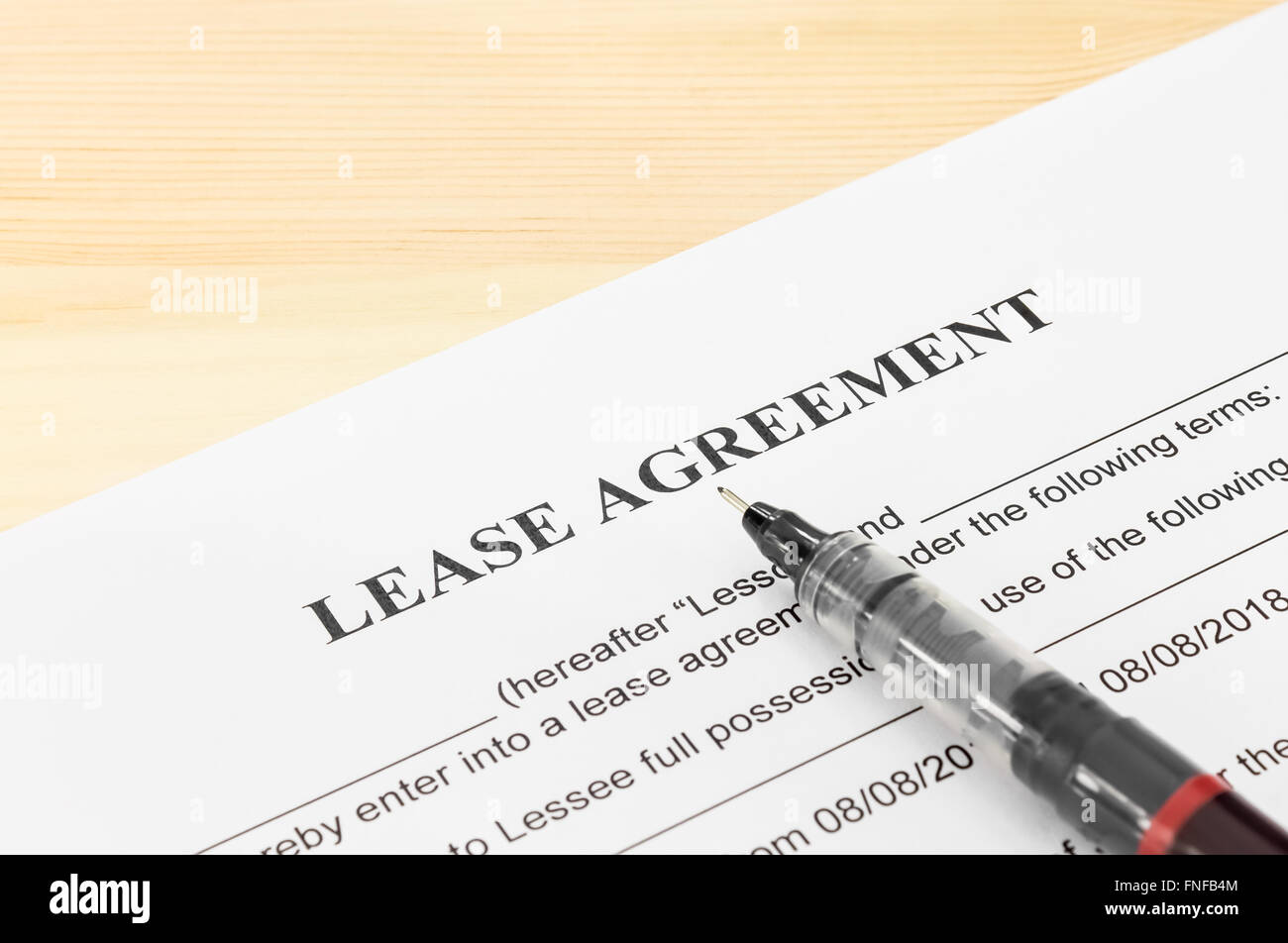 Lease agreement contract sheet and brown pen at bottom right corner on ...