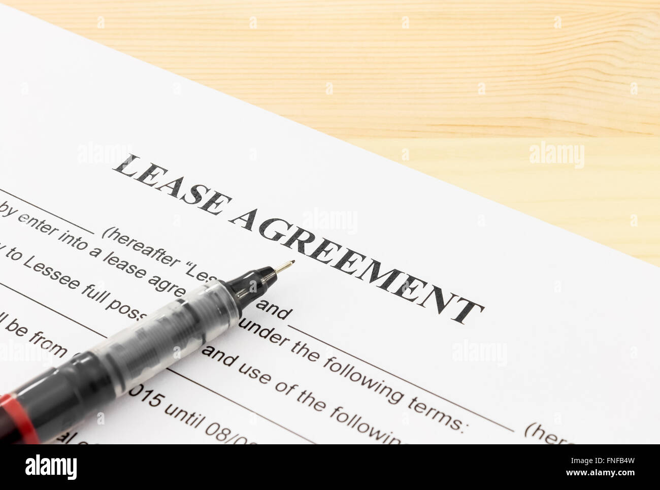 Lease agreement contract sheet and brown pen at bottom left corner on ...