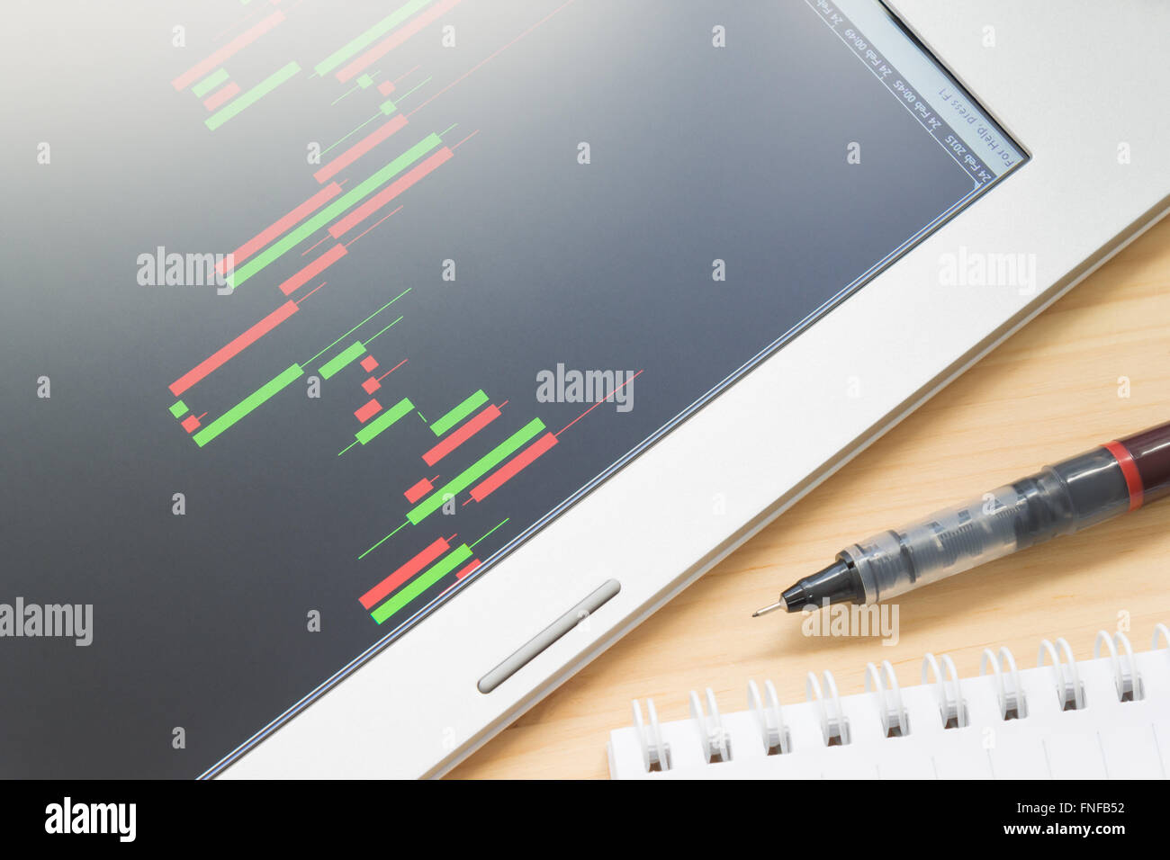 Forex graph or stock graph in black screen of tablet and pen and ...