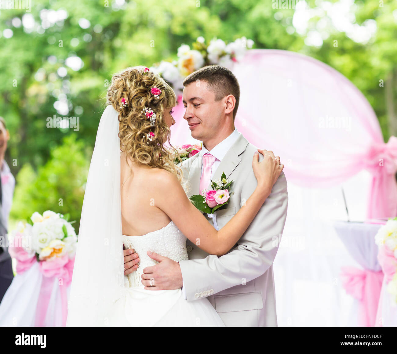 Happy newlywed romantic couple dancing at wedding aisle with pink ...