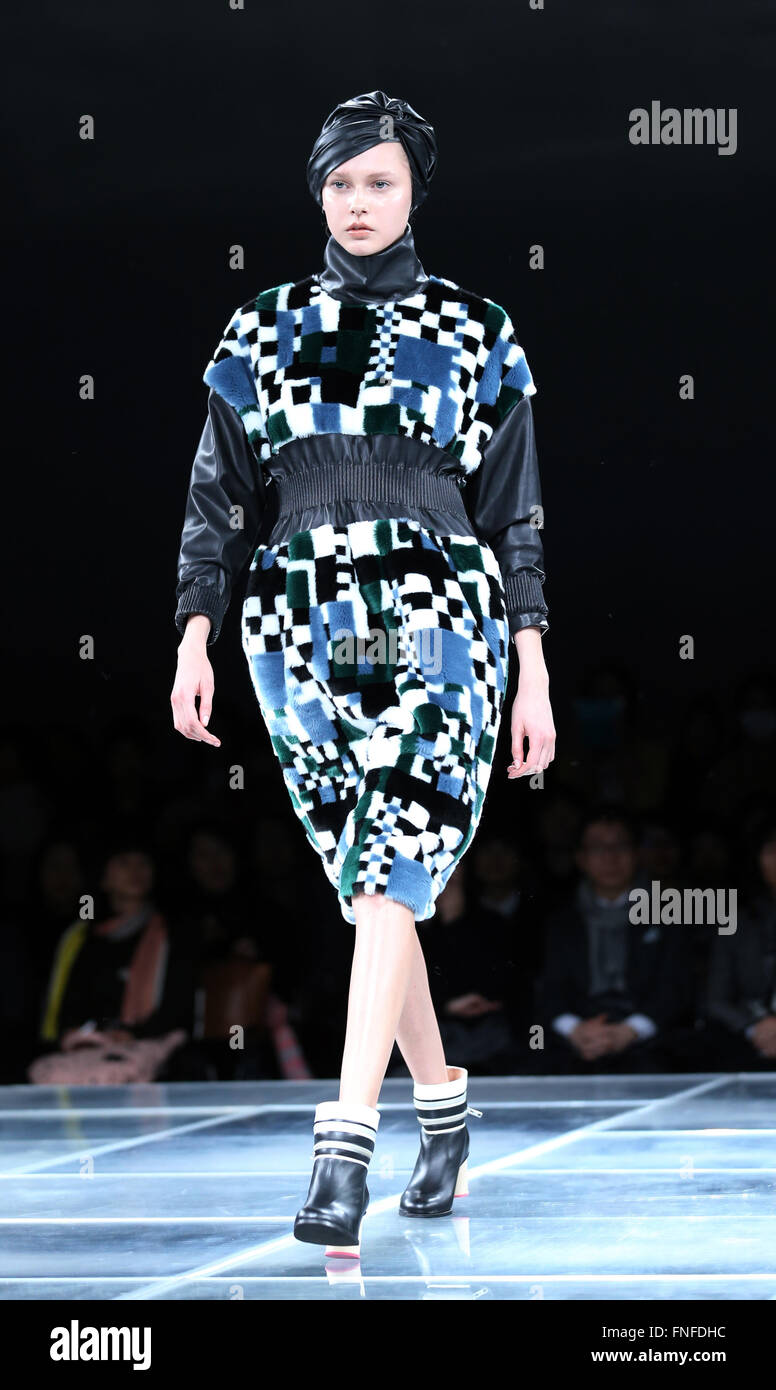 Tokyo, Japan. 15th Mar, 2016. A model displays a creation designed by ...