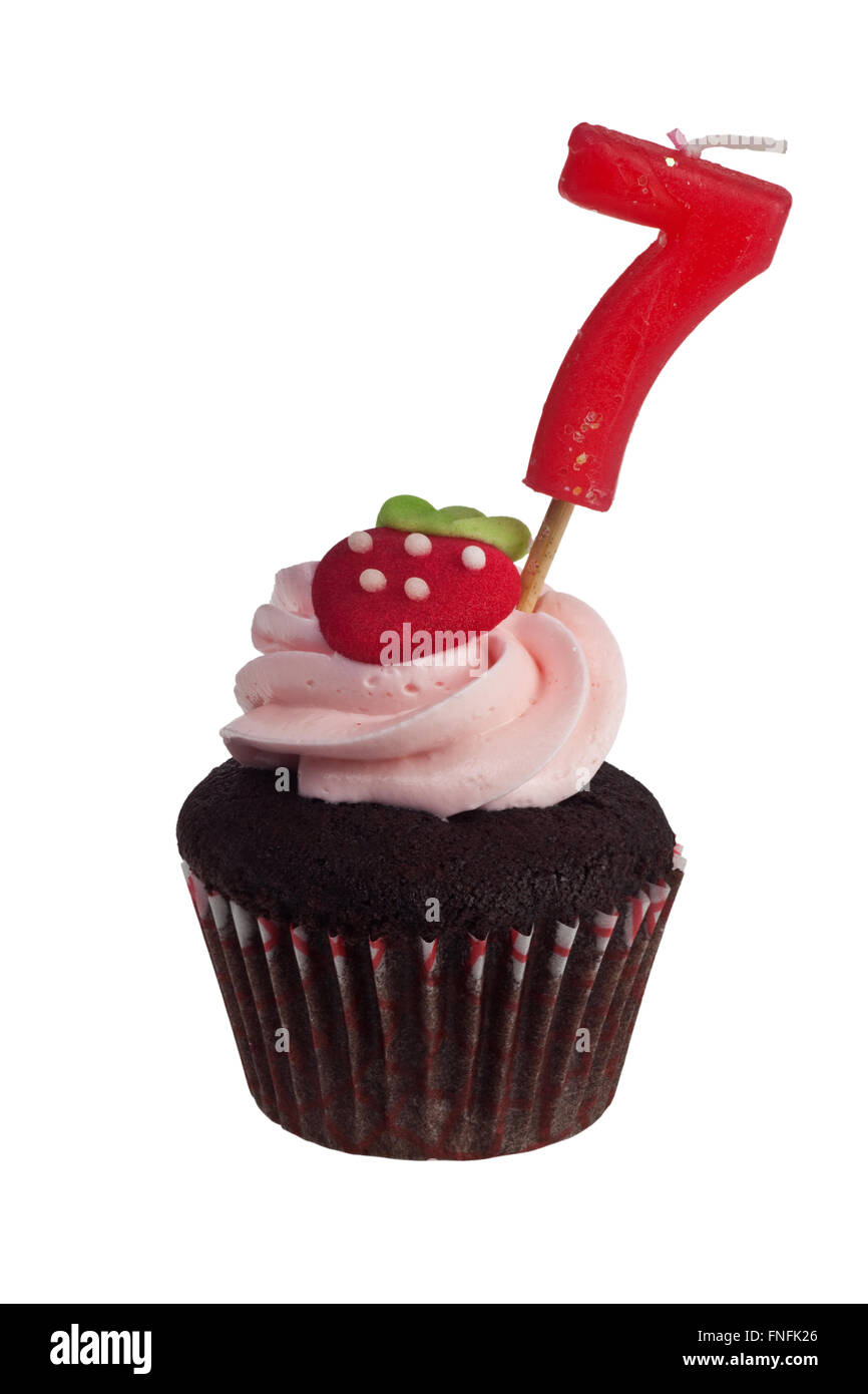 Mini cupcake with birthday candle for seven year old isolated on white ...
