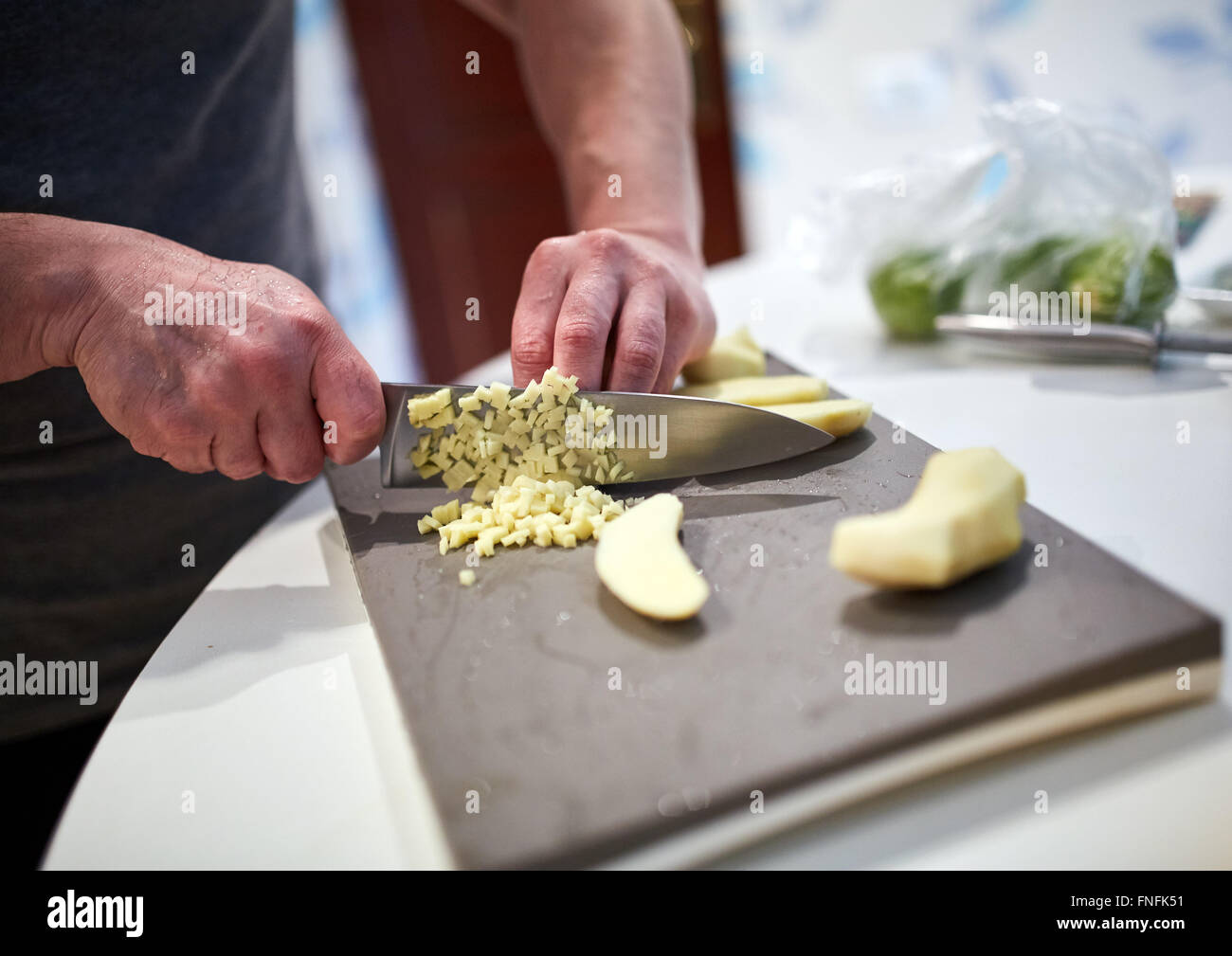 Man cooking at home, chopping ginger for a recipe Stock Photo - Alamy