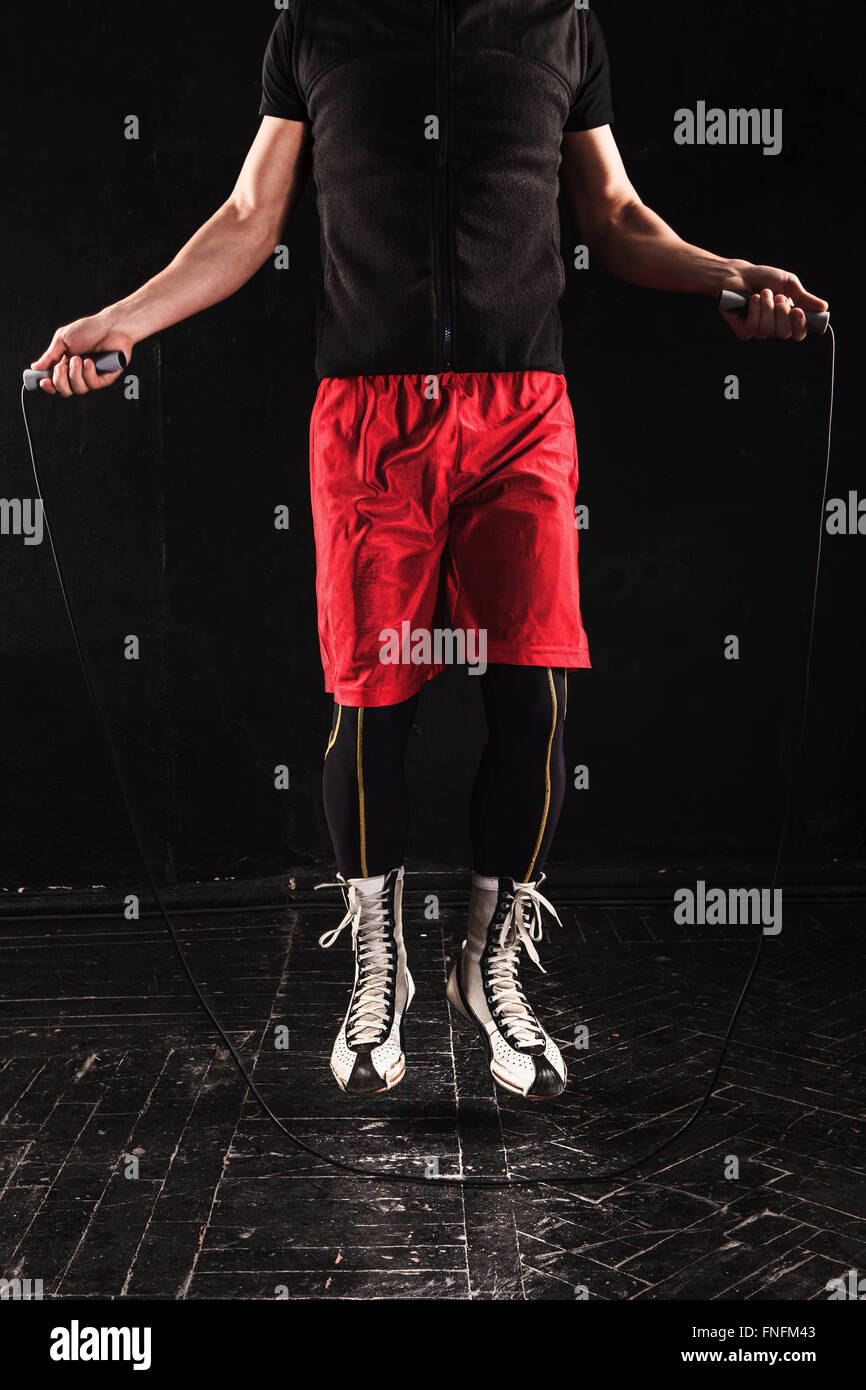 The legs of muscular man with skipping rope Stock Photo - Alamy