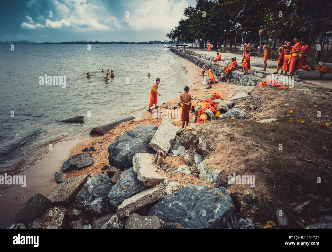 Novice monks swim in the ocean at Jittapawan Buddhist school Stock ...