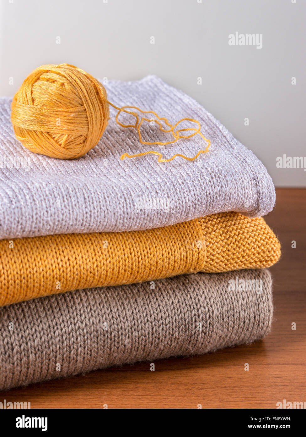 yarn and knitwear on wooden table Stock Photo - Alamy