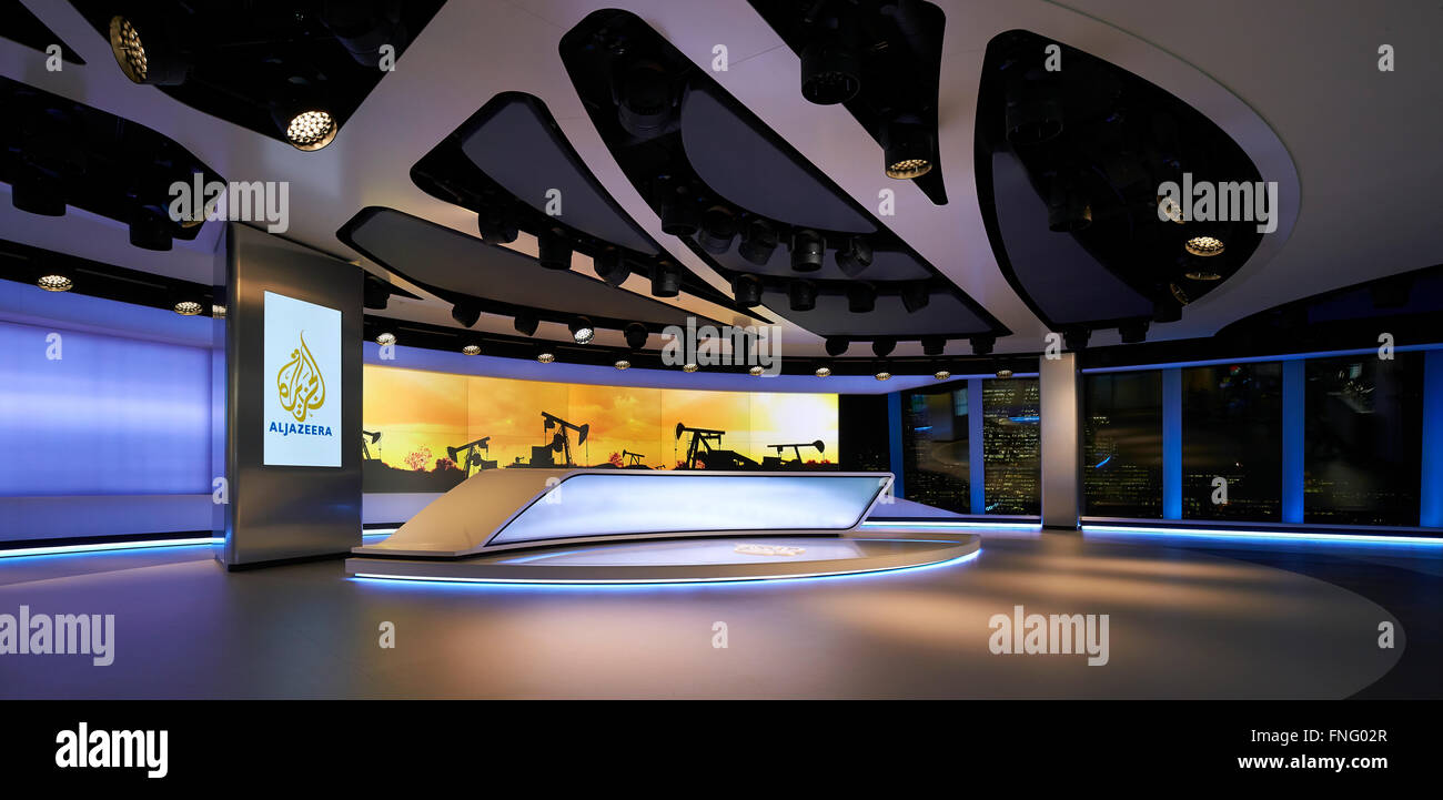 Panoramic view of news studio with illuminated desk and rear projection ...