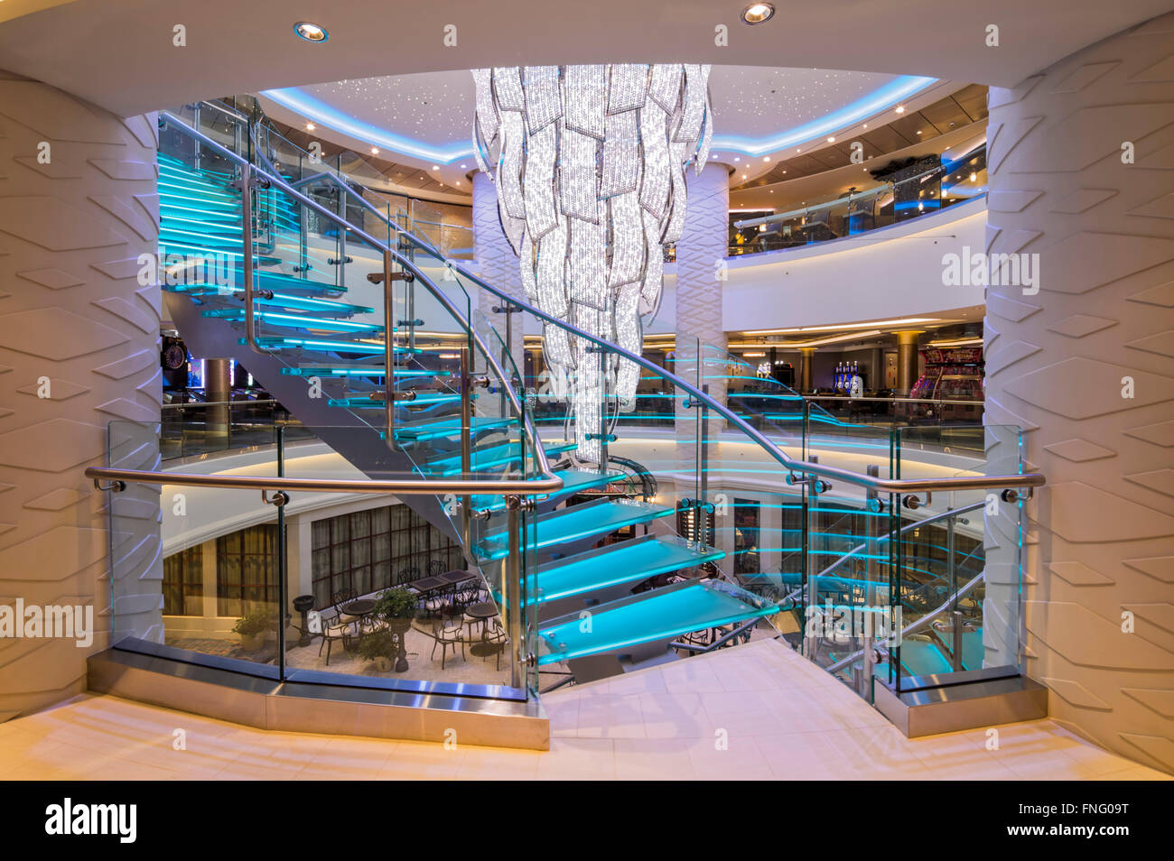 Central atrium with colour changing chandelier and glass staircase ...