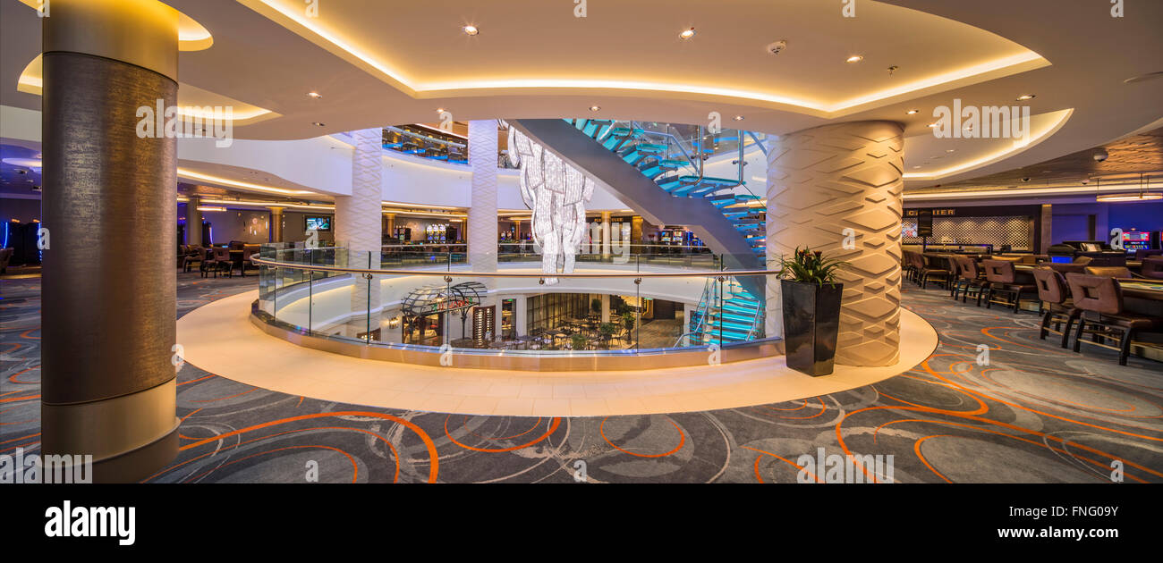 Central atrium with colour changing chandelier and glass staircase ...